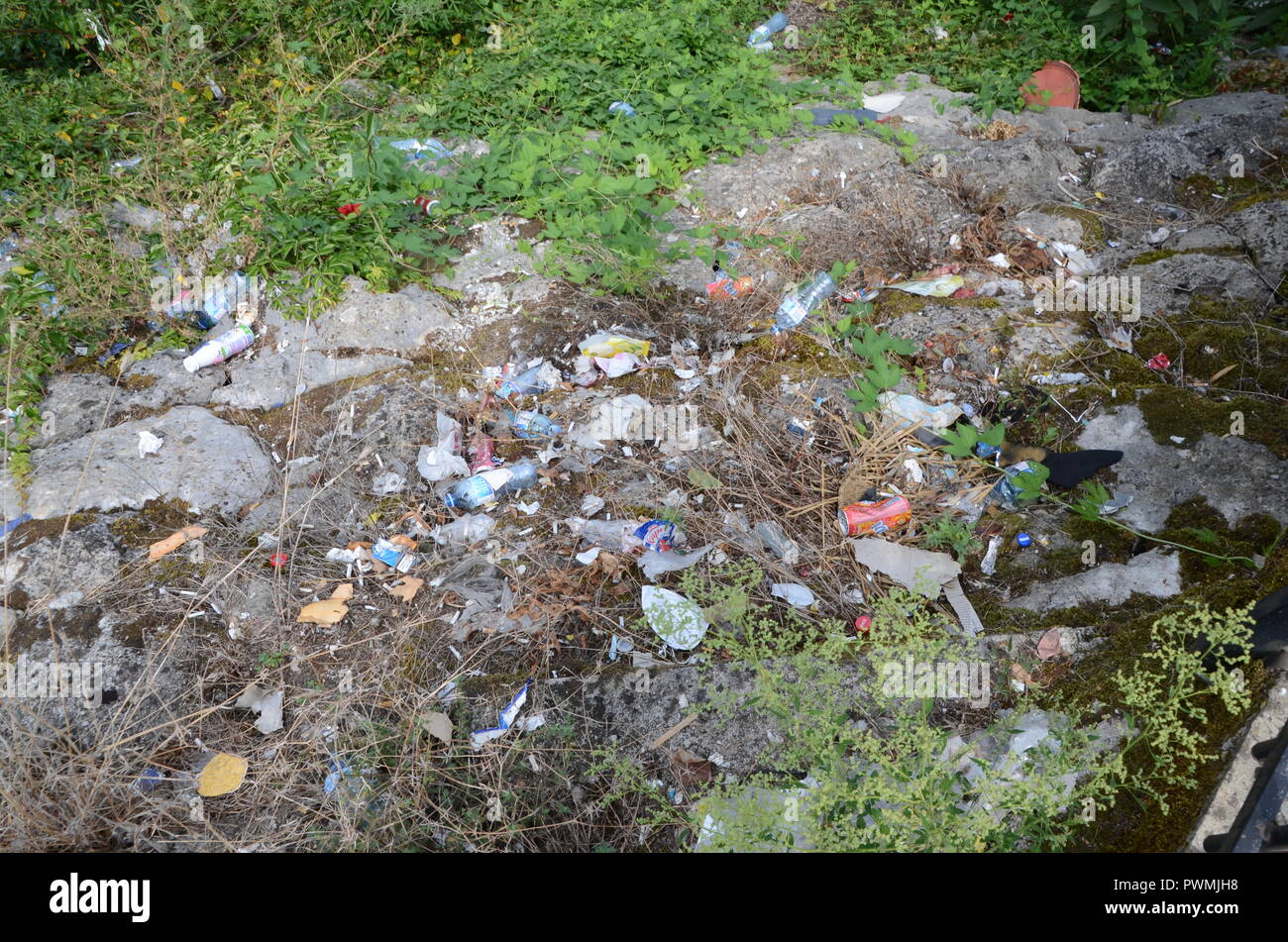 a pile of litter near lake skadar montenegro with cans and bottles and ...