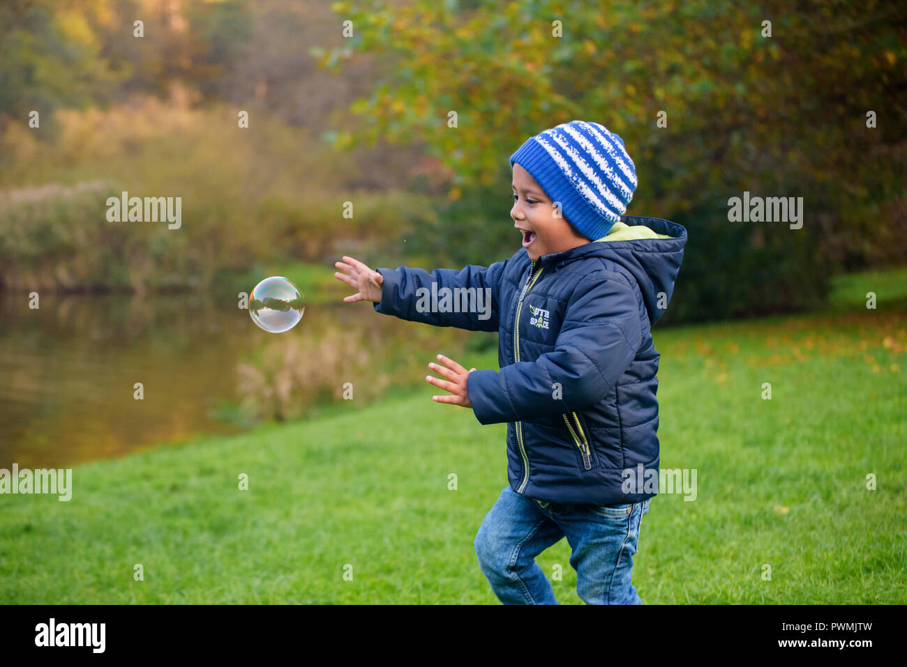 A child playing outside in fall Stock Photo - Alamy