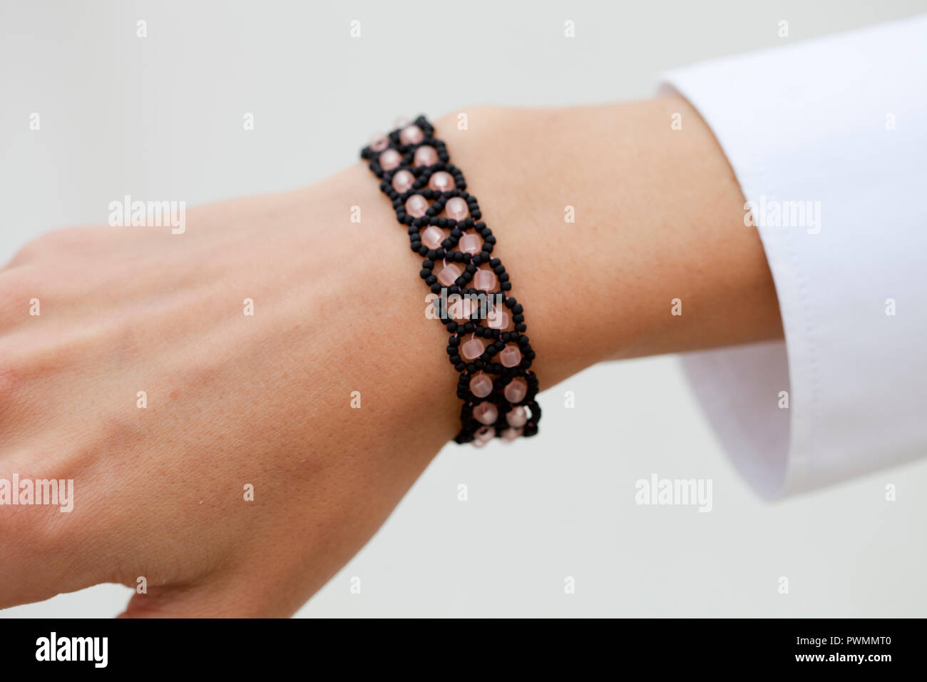 Stylish black bead bracelet on female hand - closeup Stock Photo - Alamy