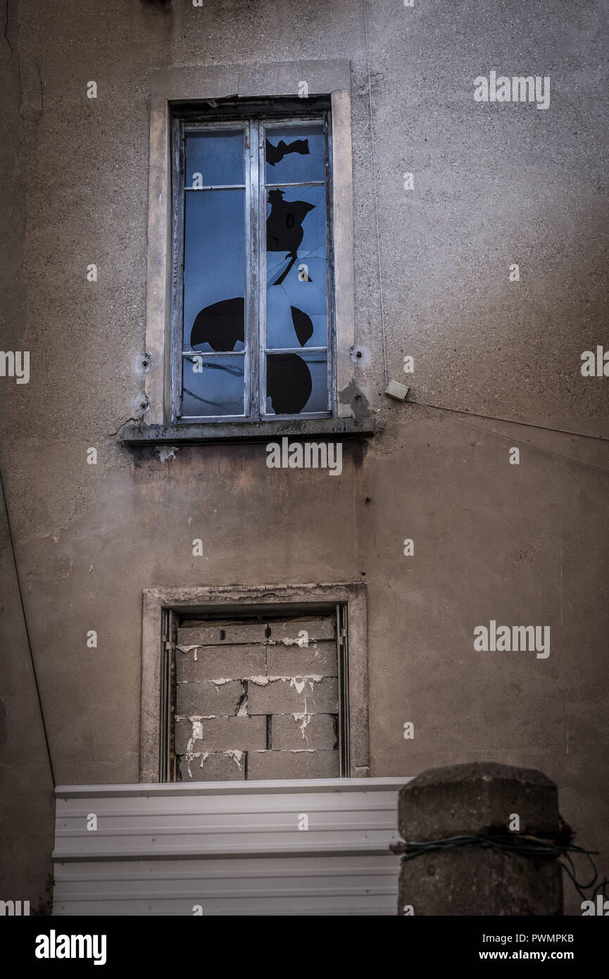 Close-up of a broken window in an old building going to be destroyed ...