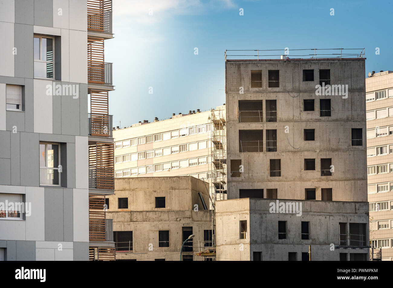Old building from the sixties and new buildings under construction in a ...