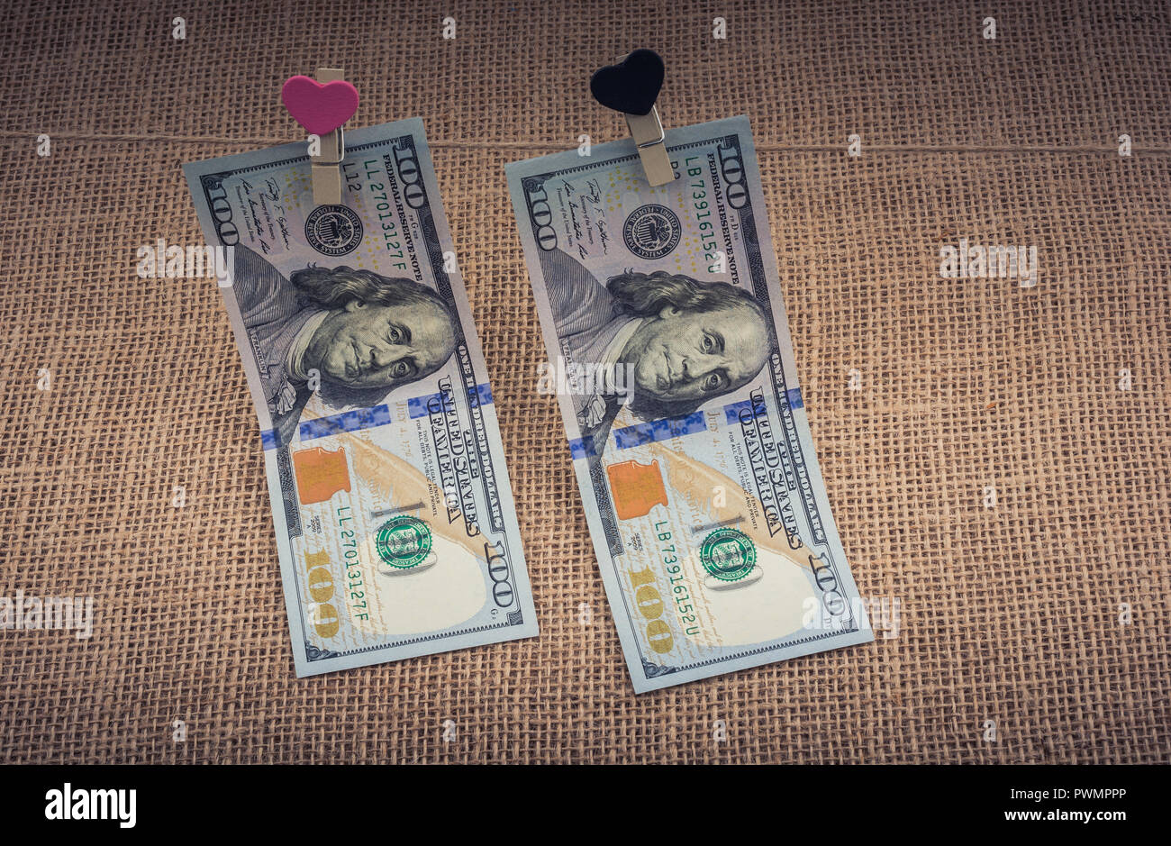 American 100 dollar banknotes with a heart clip on a string Stock Photo ...