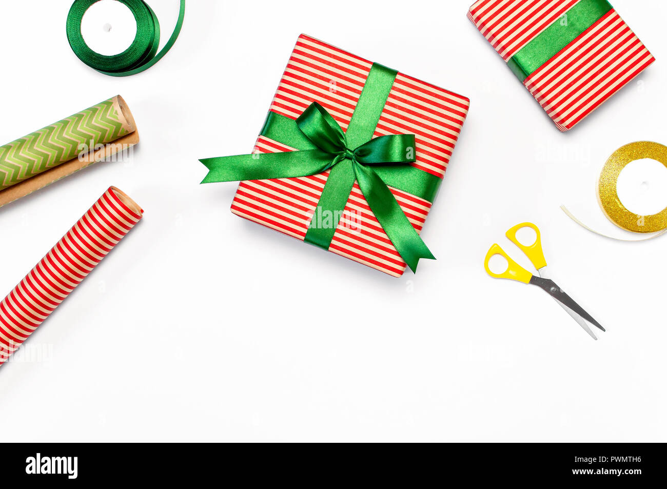 Gift boxes, packing paper, scissors, ribbon on white background ...