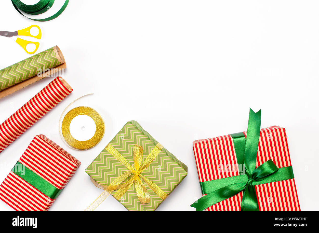 Gift boxes, packing paper, scissors, ribbon on white background ...