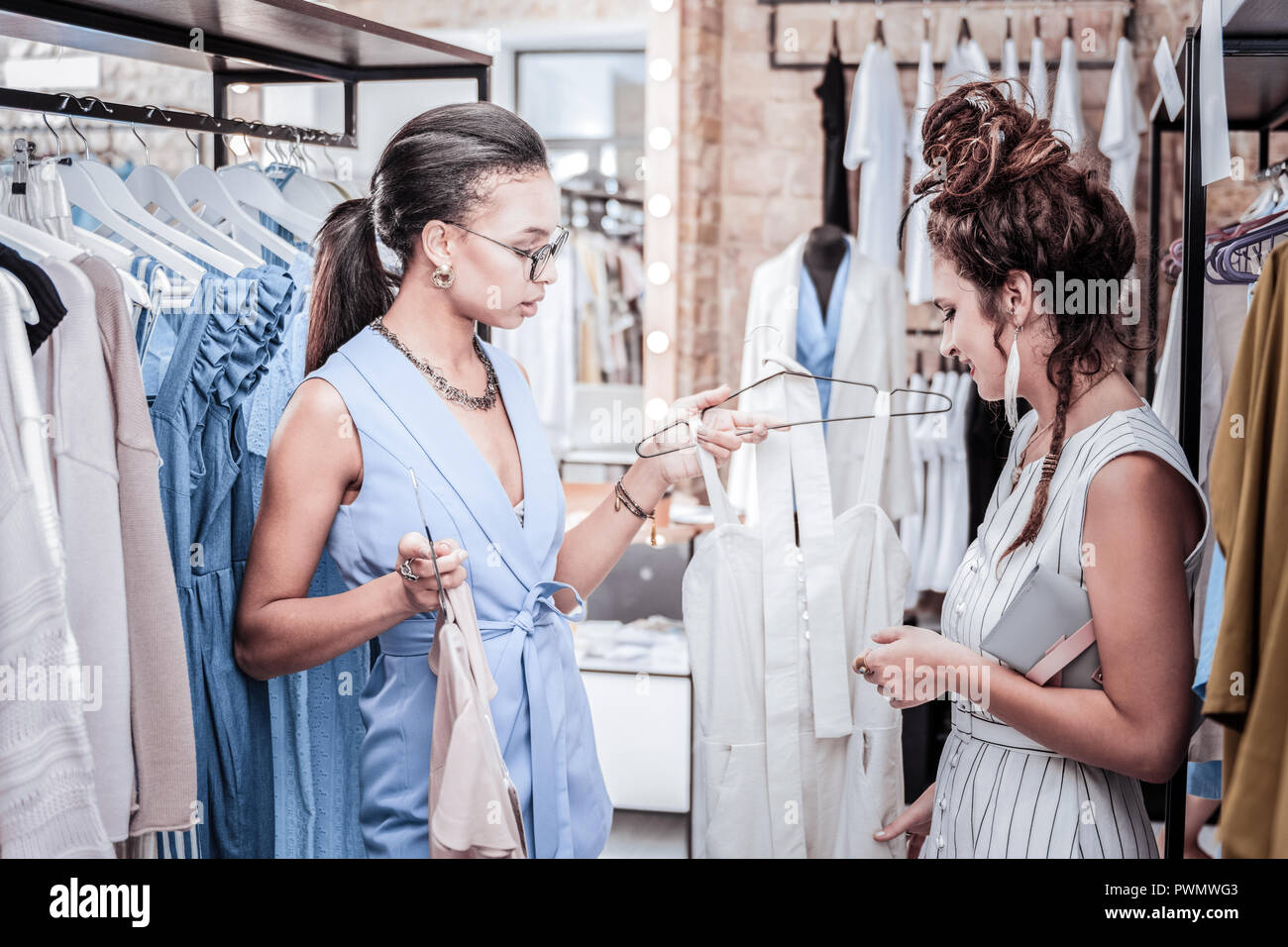Shopping assistant offering her constant client variants of summer ...