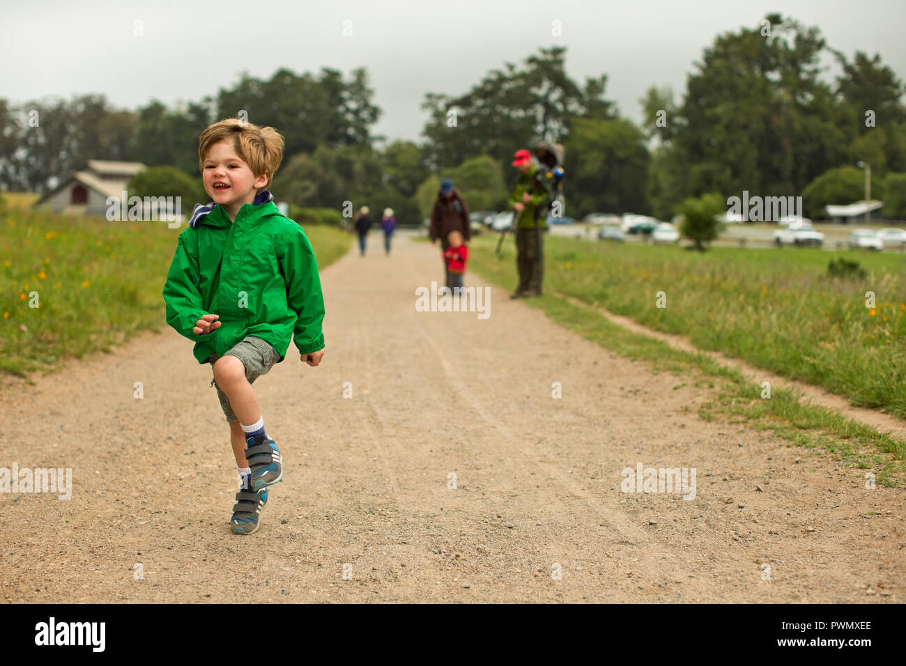 Happy young boy skipping along a trail Stock Photo - Alamy