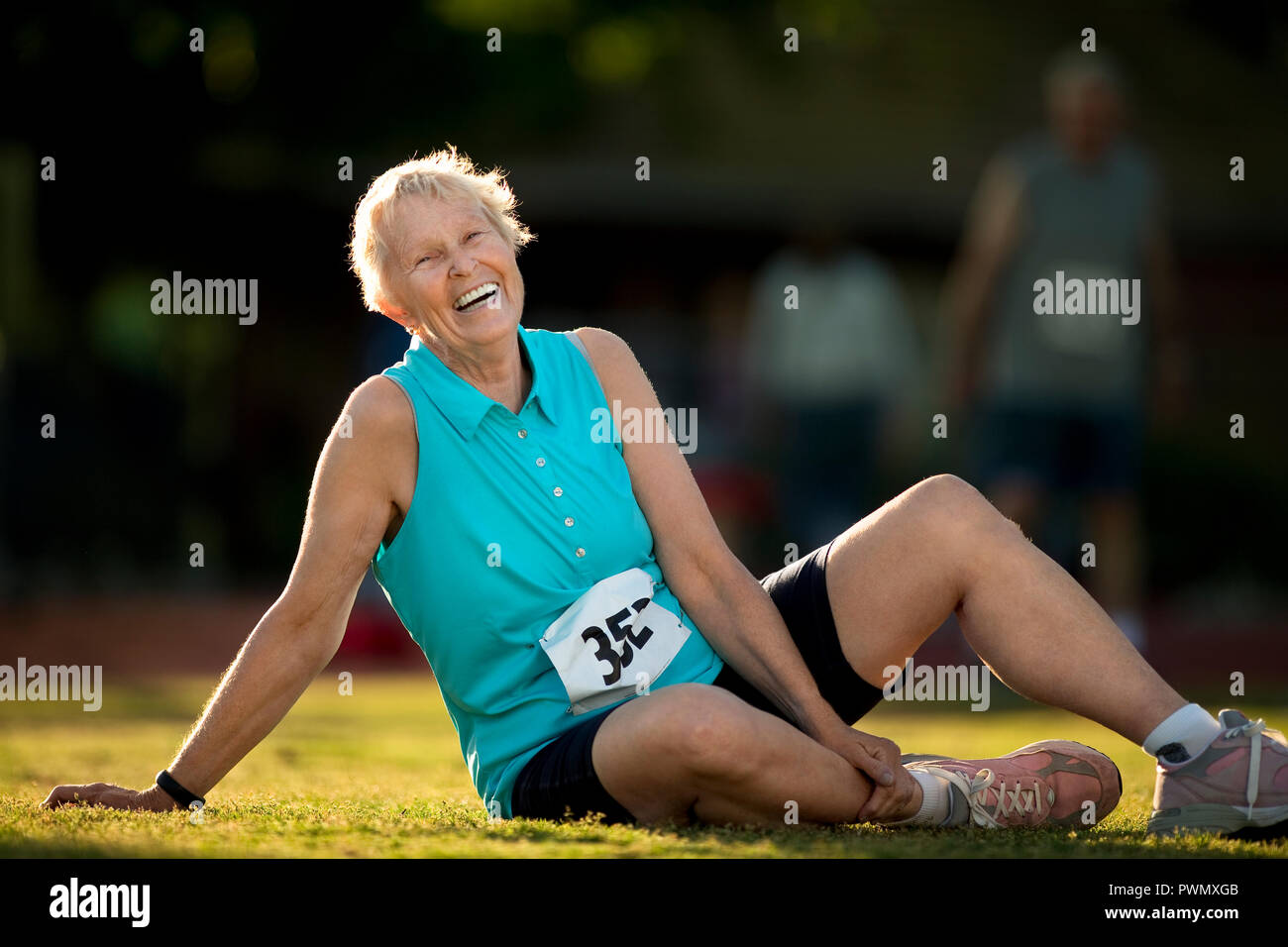 Portrait of a smiling senior woman resting after competing in a running ...