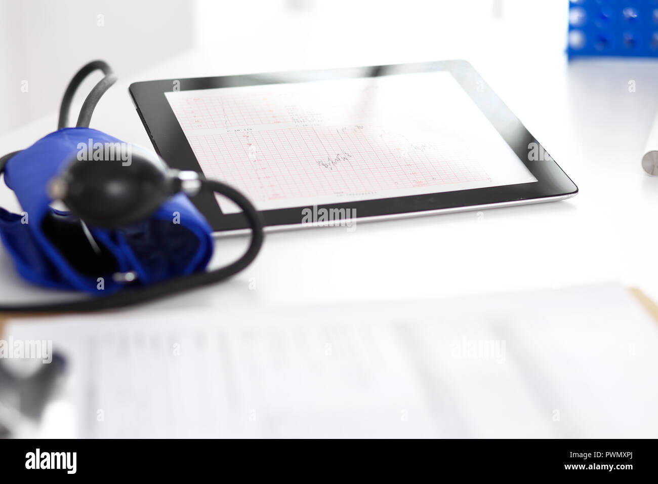 Workplace of doctor. Tablet ps showing heart diagrams closeup ...