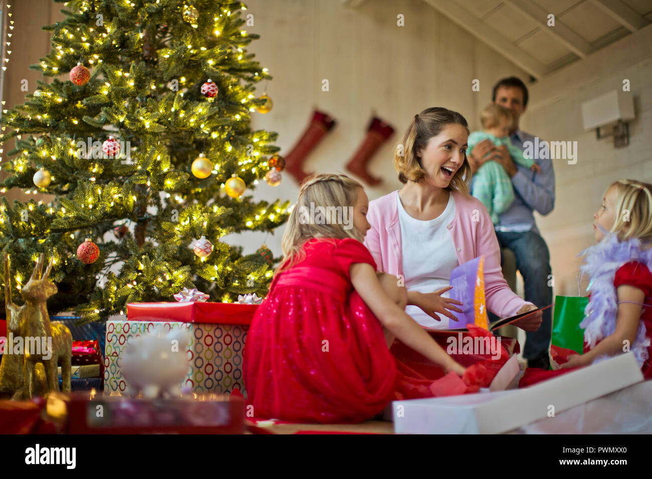 Family unwrapping Christmas gifts Stock Photo - Alamy