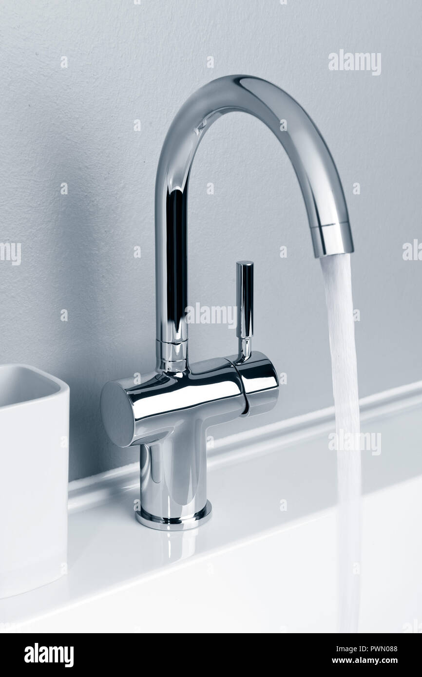 Water runs out of a big tap in bathroom Stock Photo - Alamy