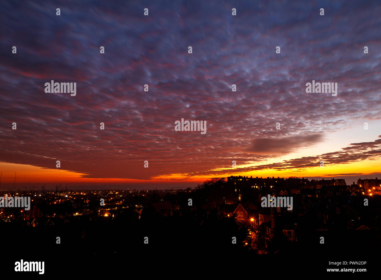 The setting sun lighting up the cloud-cover Stock Photo - Alamy