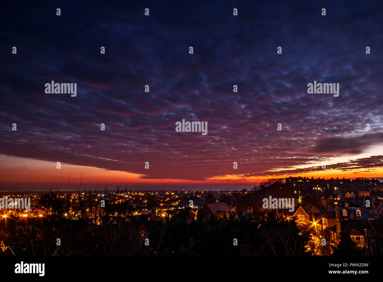 The setting sun lighting up the cloud-cover Stock Photo - Alamy