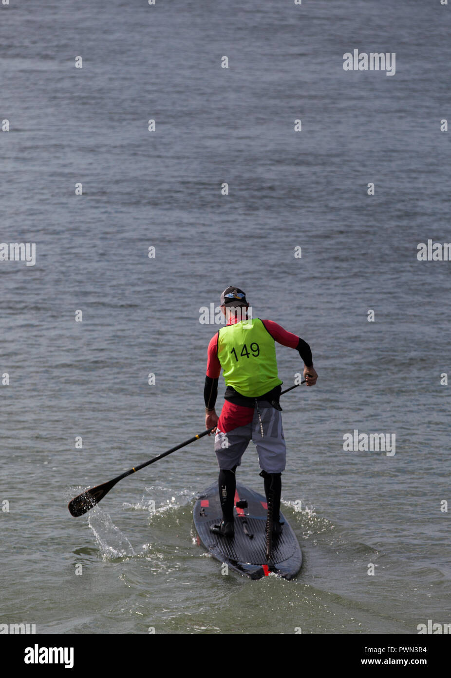 Back of a paddle boarder while in a completion Stock Photo - Alamy