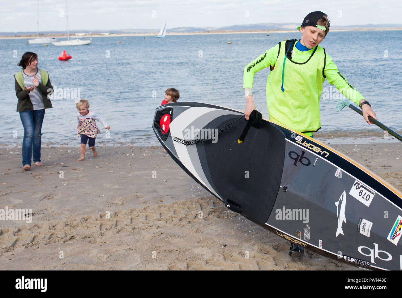 Teenager finishing a paddle board race Stock Photo - Alamy