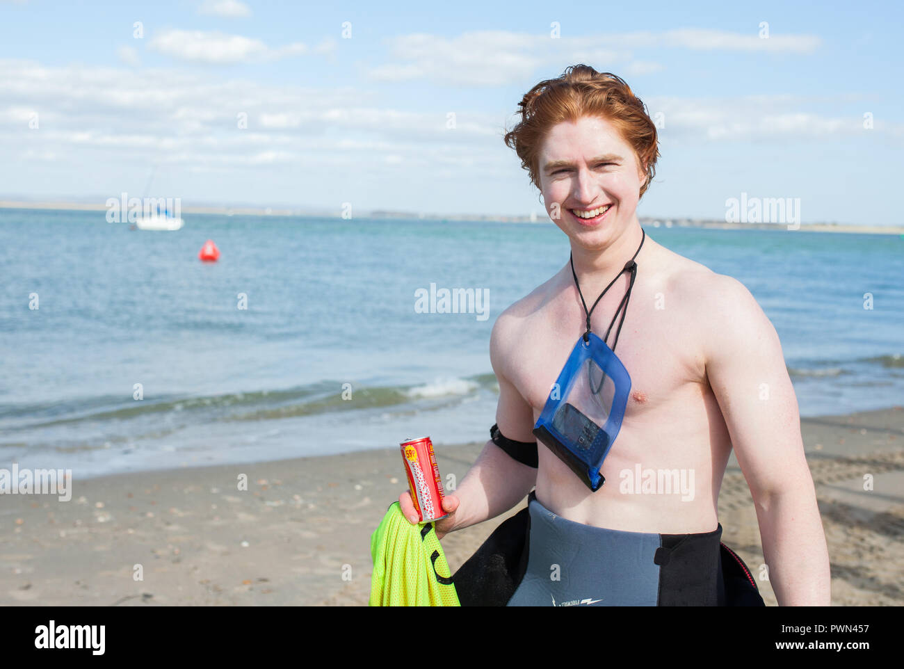 young man finishing a paddle board race with bare chest Stock Photo - Alamy