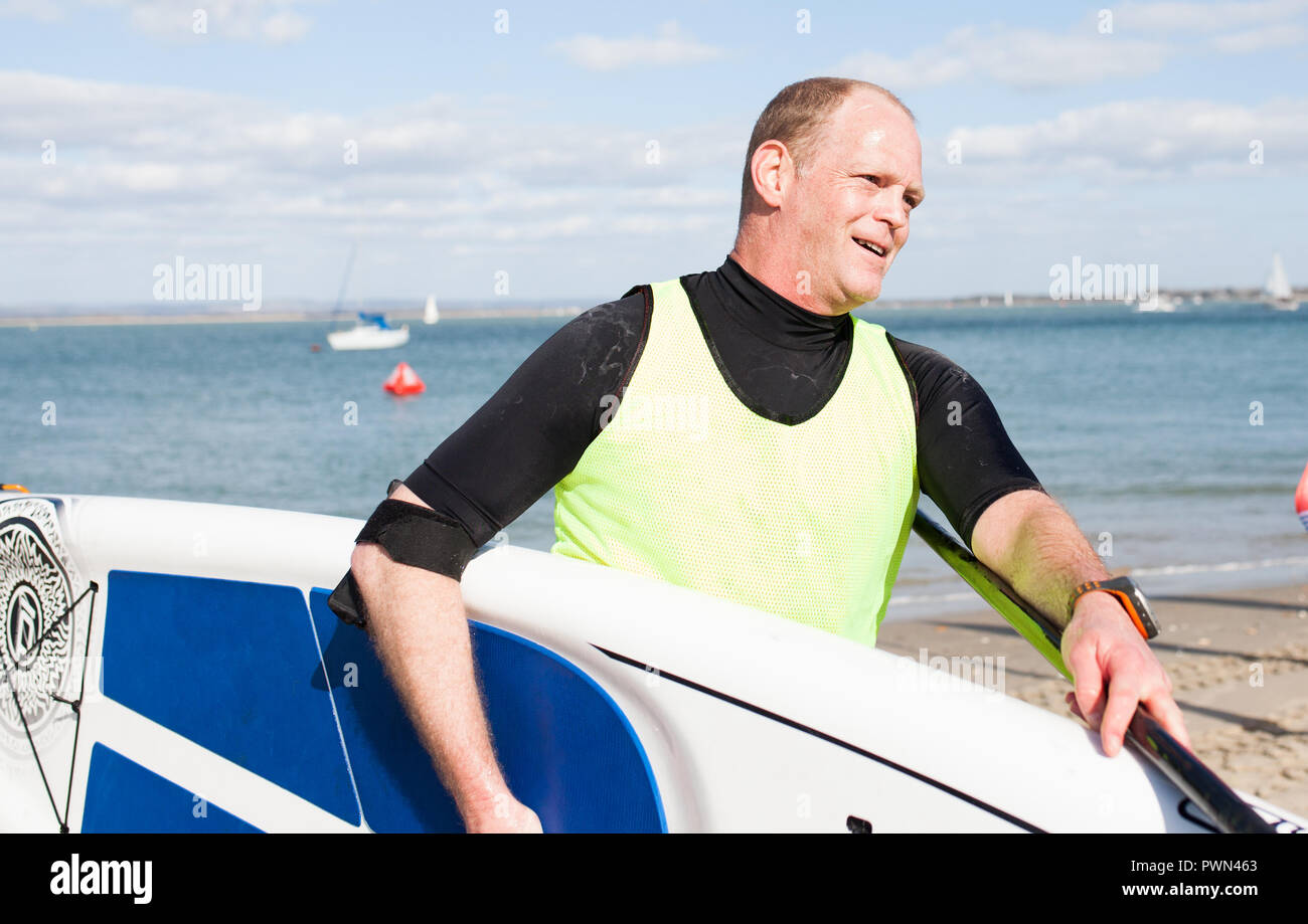 Man Carrying Paddle Board Into Sea High Resolution Stock Photography ...