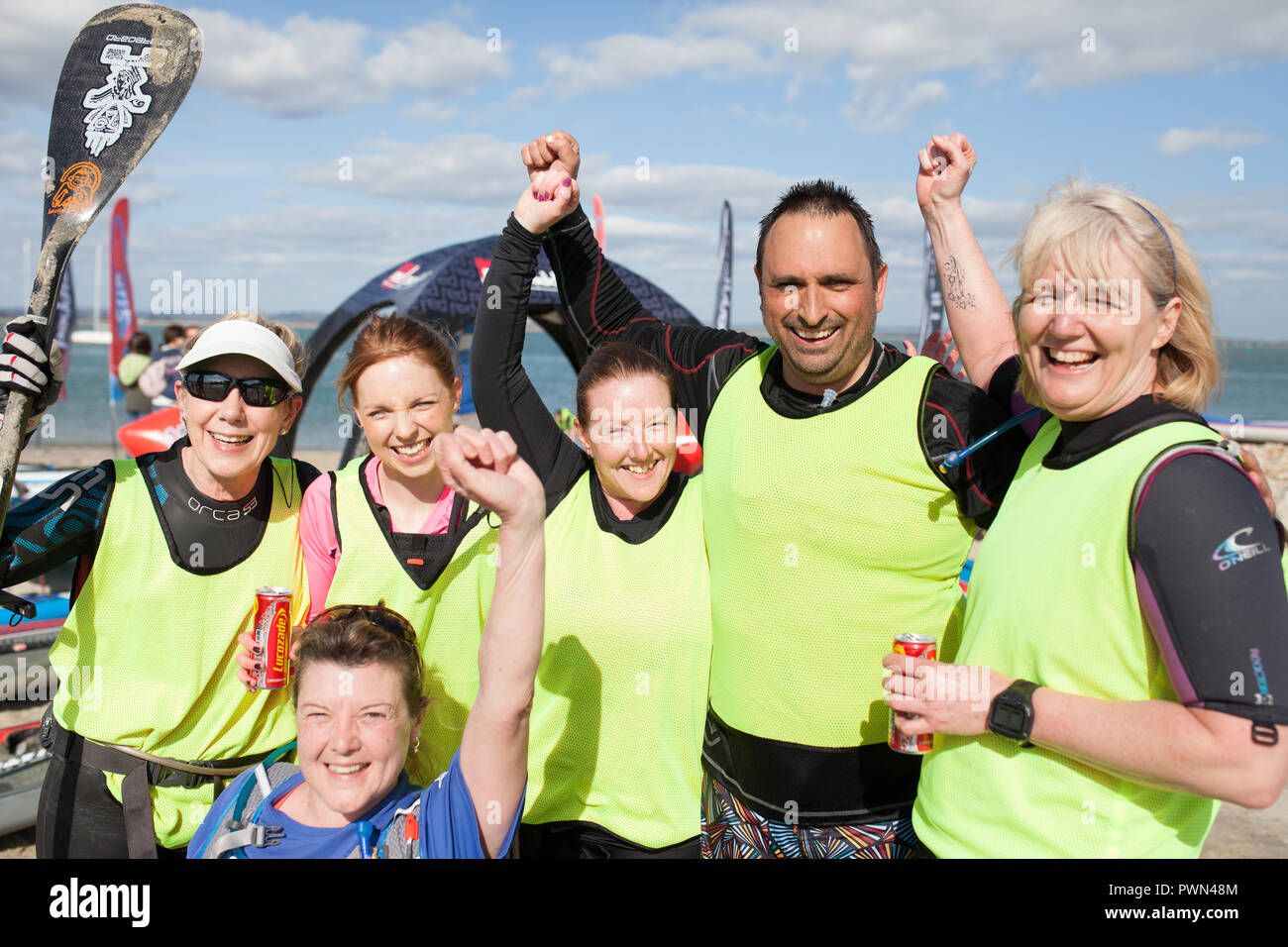 Family picture after taking part in a paddle board race Stock Photo - Alamy