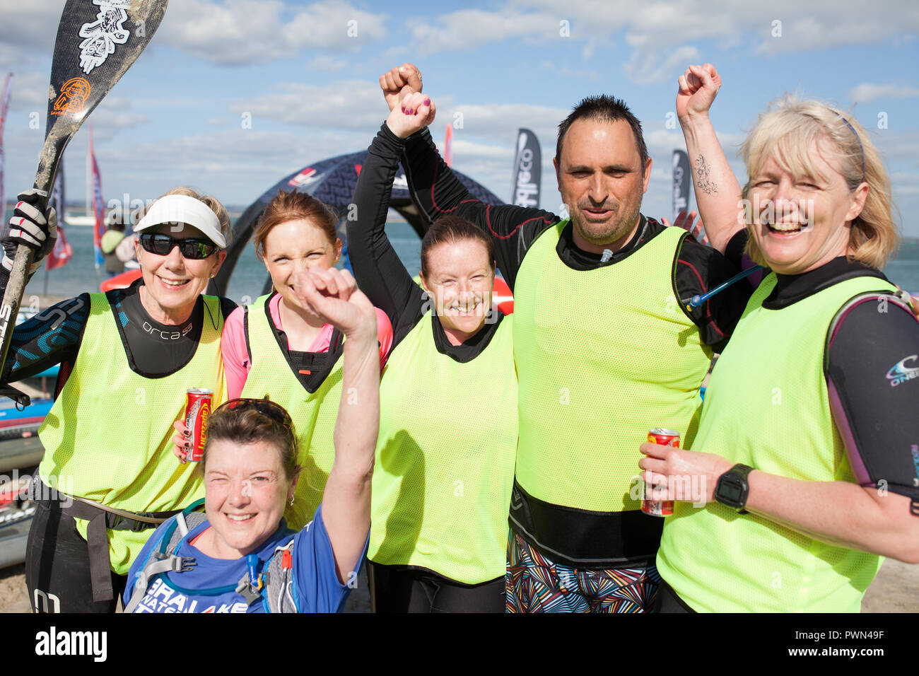 Family picture after taking part in a paddle board race Stock Photo - Alamy