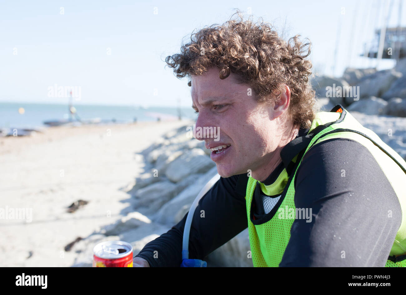 Man exhausted after taking part in a paddle board race Stock Photo - Alamy
