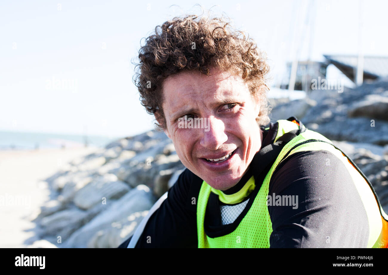 Man exhausted after taking part in a paddle board race Stock Photo - Alamy
