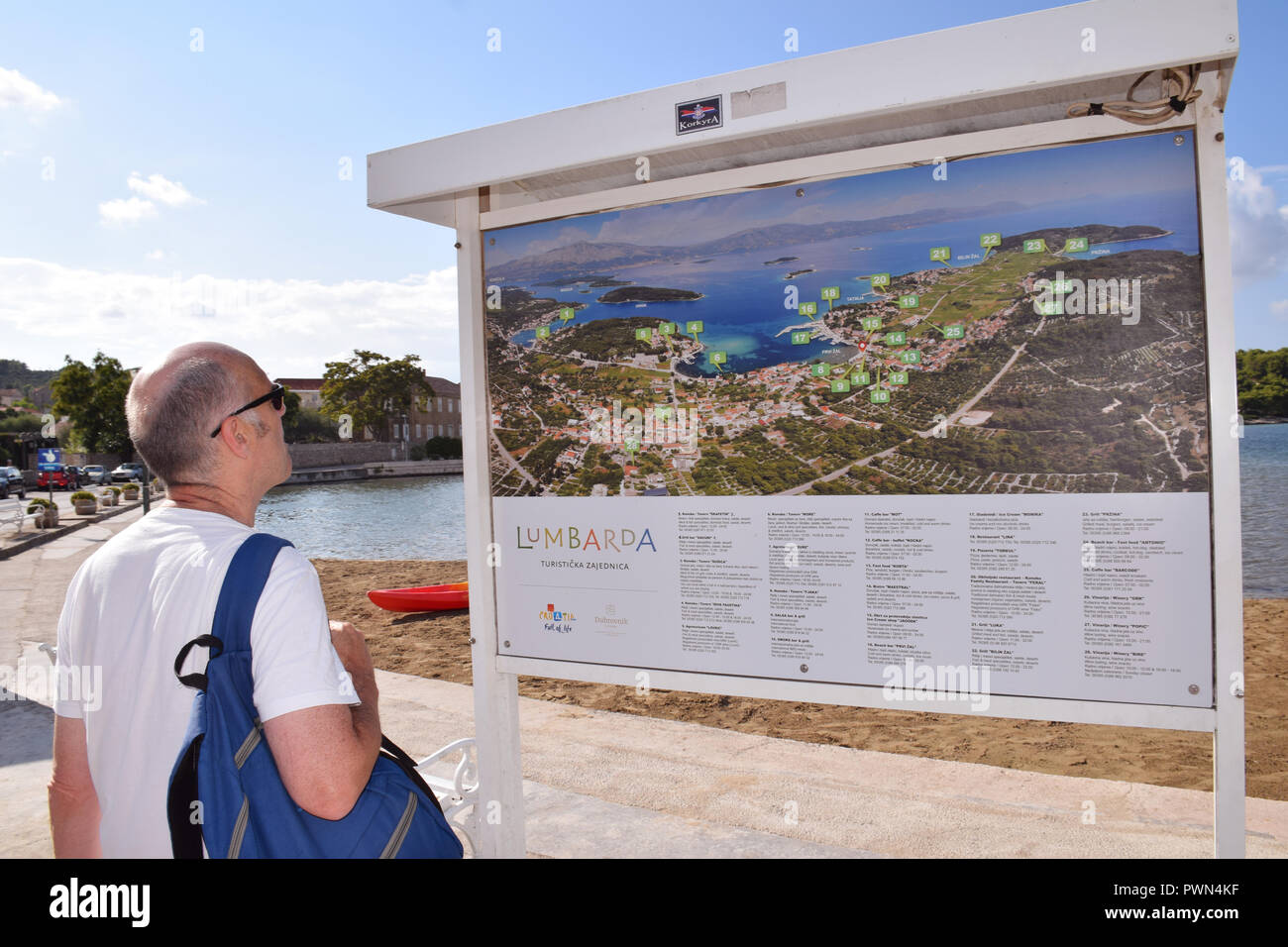 British tourist looking at map, Lumbarda, Korcula island, Croatia, Sep ...