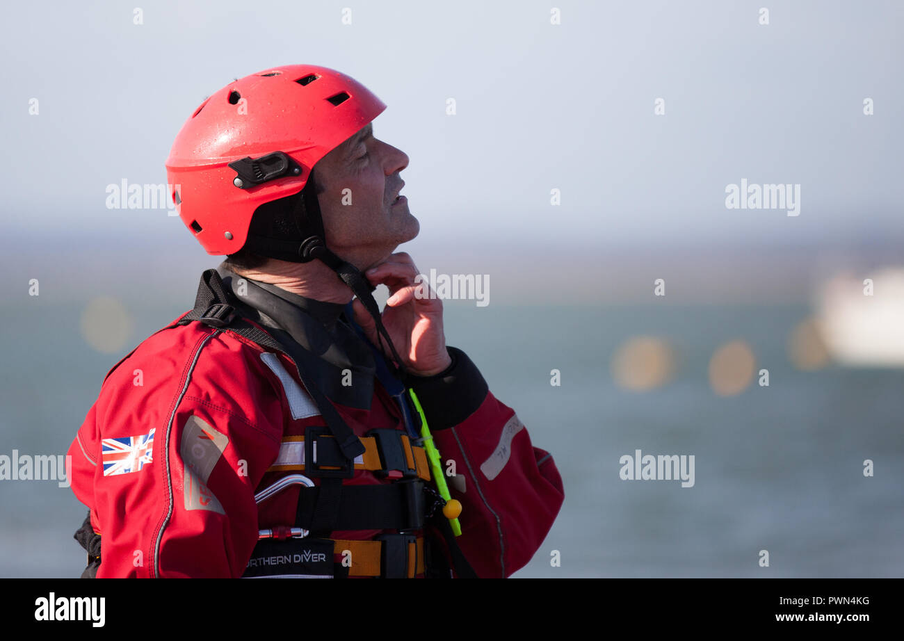 Coast guard worker taking off his safety helmet Stock Photo - Alamy