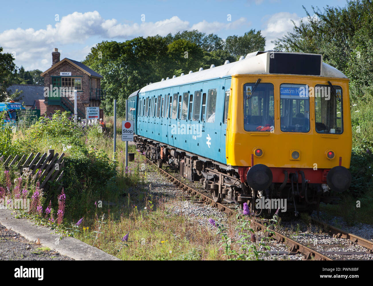 A diesel multiple unit passenger train leaving Wensleydale Railway’s ...