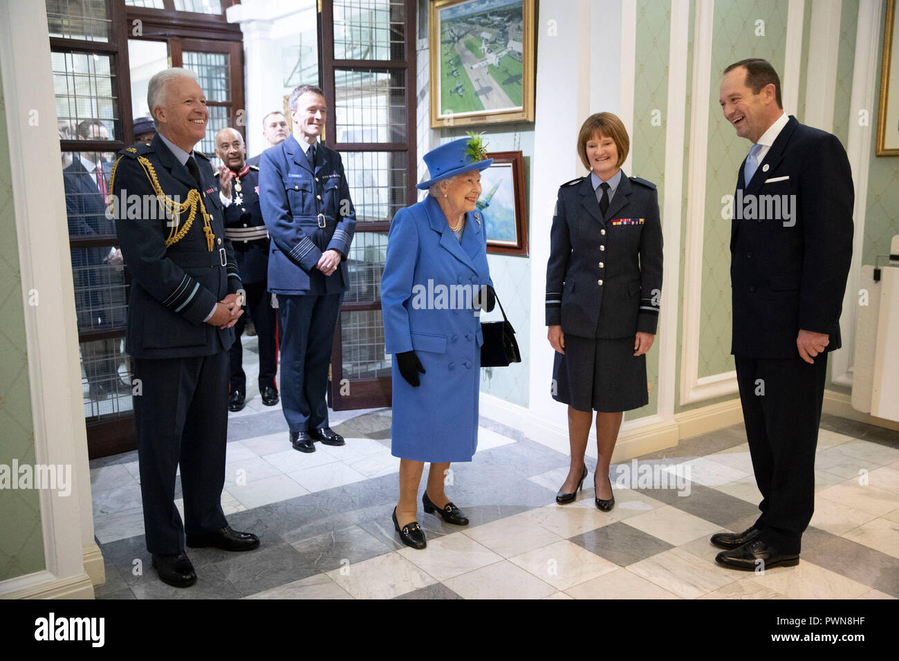 Queen Elizabeth II walks through the RAF Club with Air Marshall Sir ...