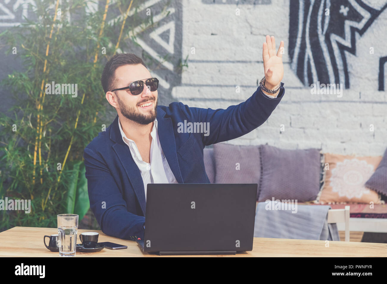 Portrait of businessman calling waiter in coffee shop Stock Photo - Alamy