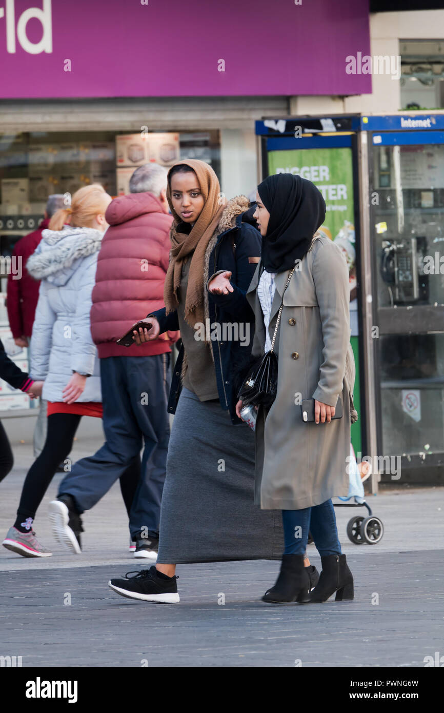 Two young muslim girls walking on the High St wearing their hijabs Stock Photo - Alamy