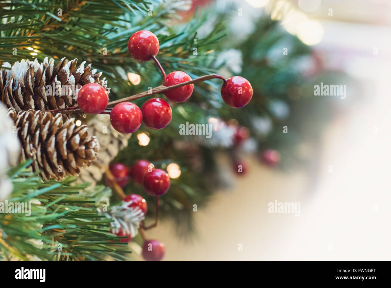 Christmas tree with red berries and cone as decor. Xmas. Close up Stock ...
