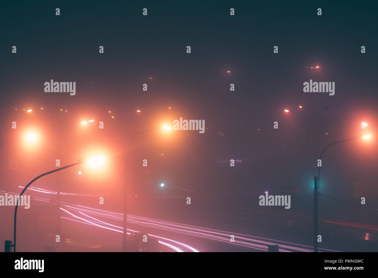 Neon lights of night city and motion traffic in fog. Retro colored ...