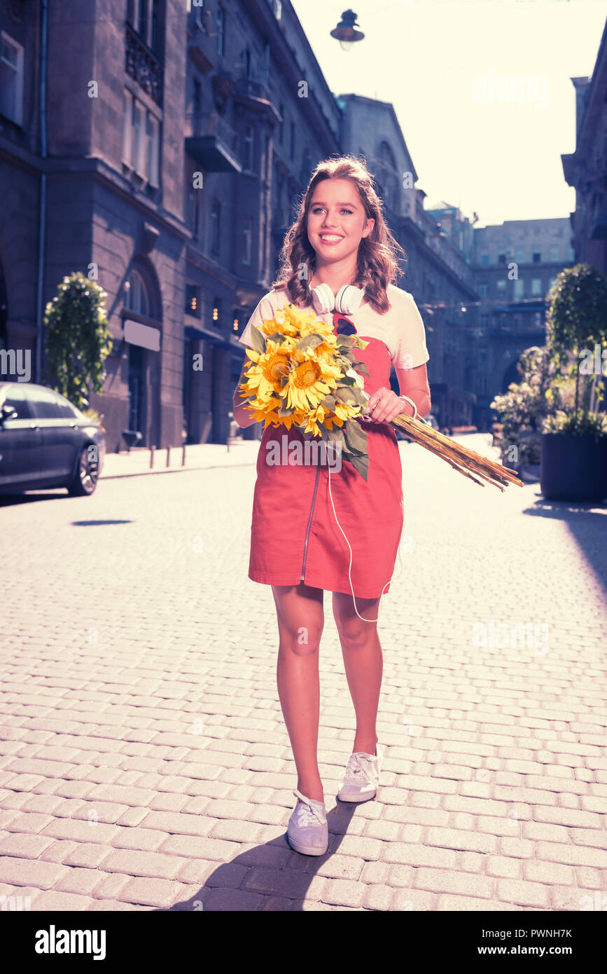 Happy beaming young woman coming back home from romantic date Stock ...