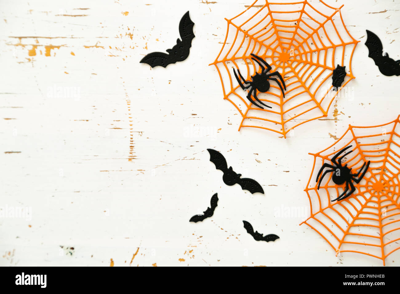 Halloween concept - spiders, bats, web paper crafts on bright ...