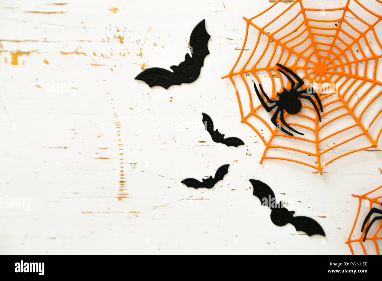 Halloween concept - spiders, bats, web paper crafts on bright ...