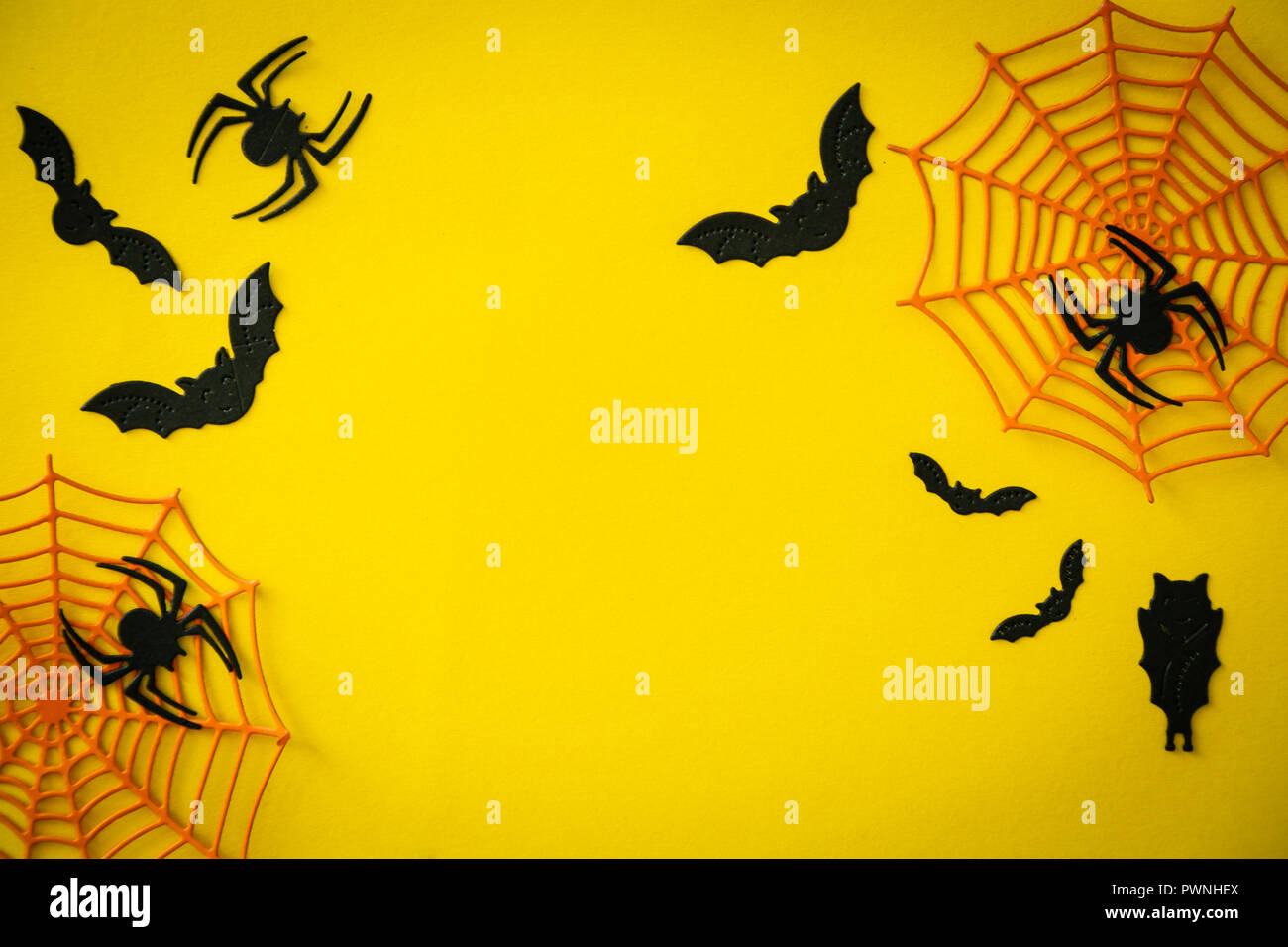 Halloween concept - spiders, bats, web paper crafts on bright ...