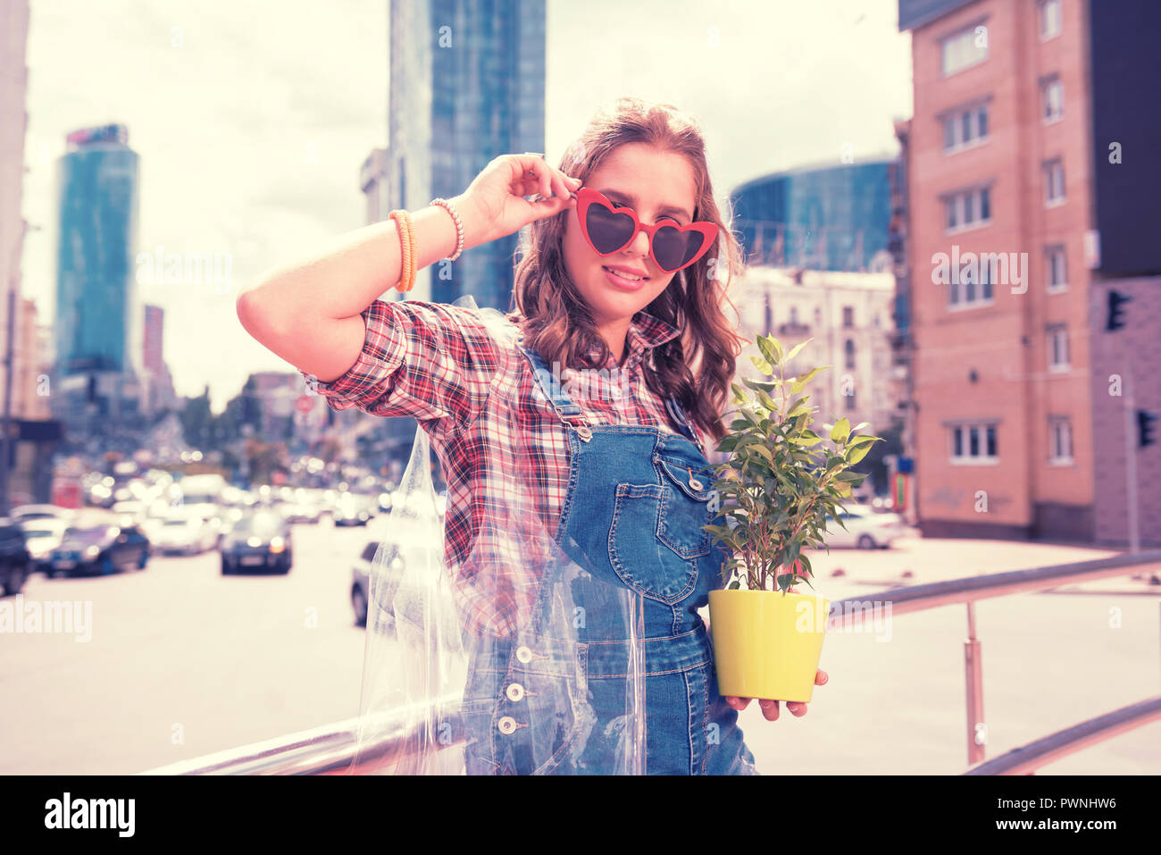 Dark-haired curly woman wearing bright red heart shape sunglasses Stock ... Dark-haired curly woman wearing bright red heart shape sunglasses Stock ...