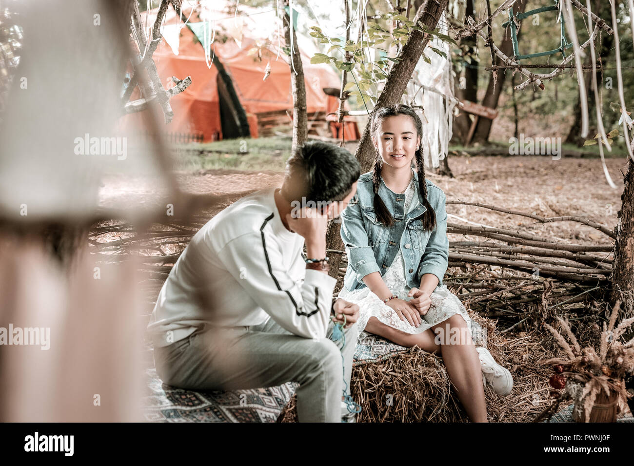 Attentive international man looking at his girlfriend Stock Photo - Alamy