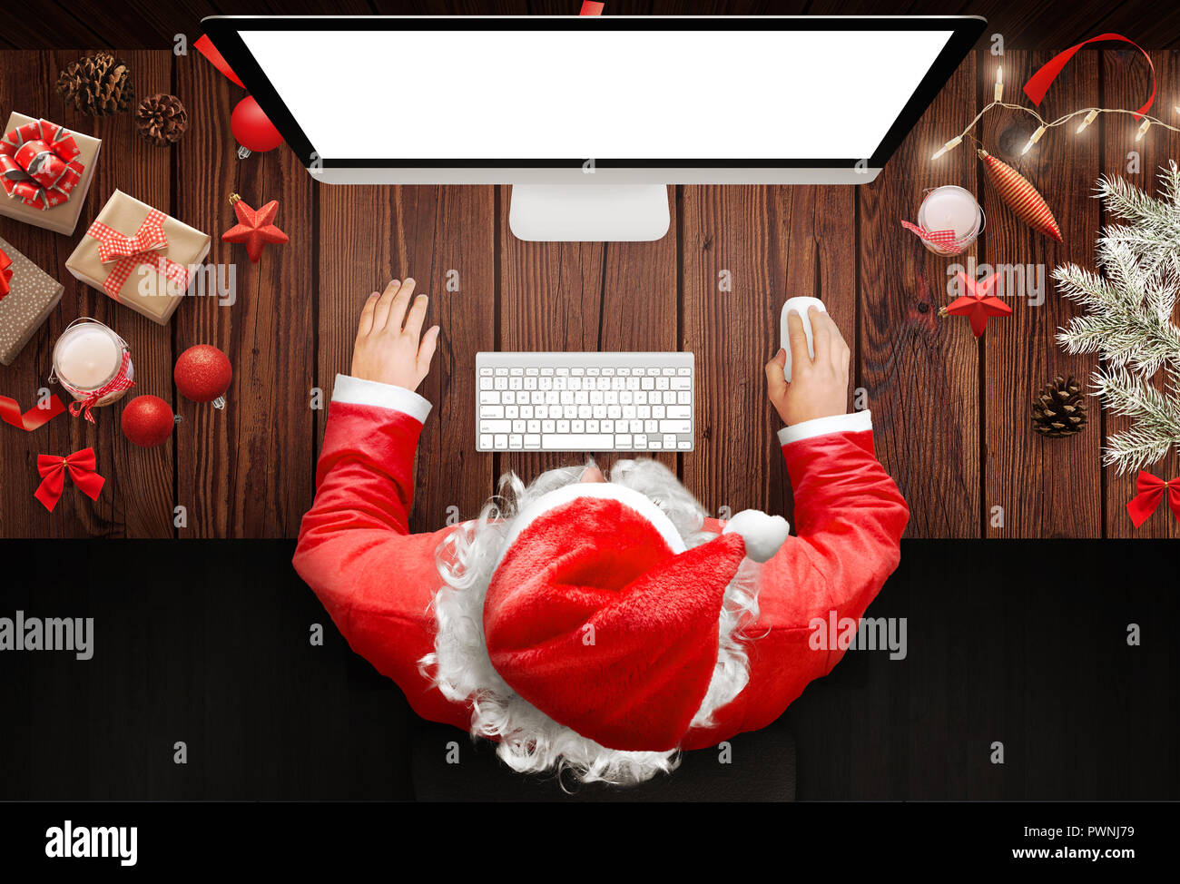 Christmas in Santa Claus home. Santa Claus use a computer to respond to ...