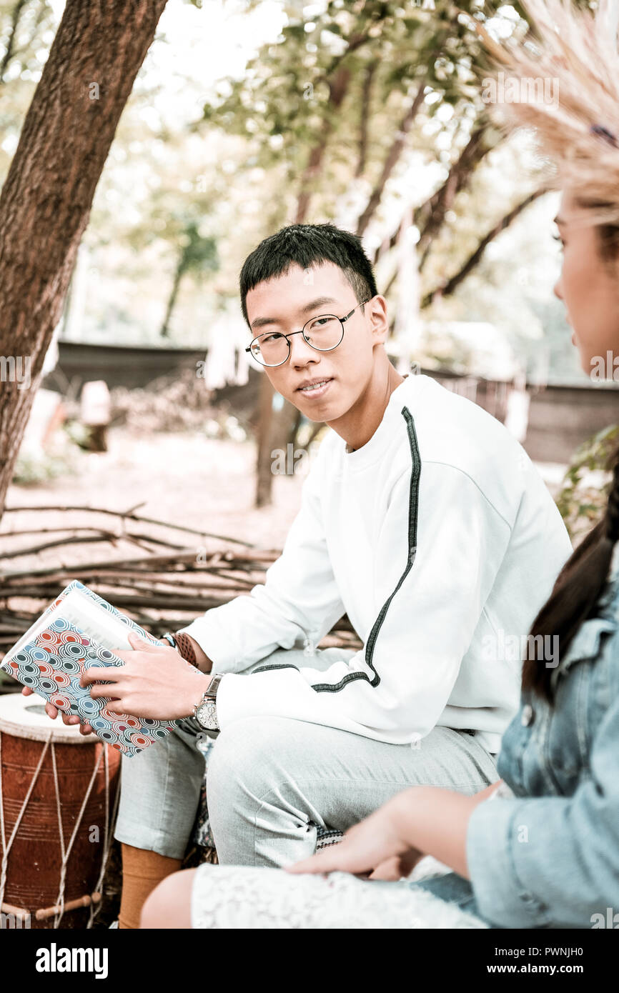 Delighted Asian male person staring at his friend Stock Photo - Alamy