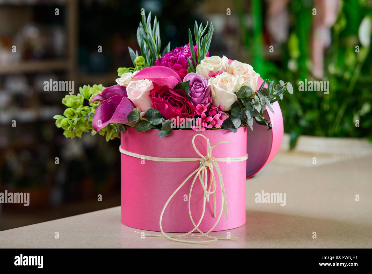 Pink box with flower bouquet Stock Photo - Alamy