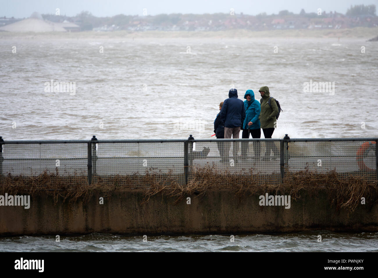 UK Weather. People walking on the promenade on a windy stormy day Stock ...