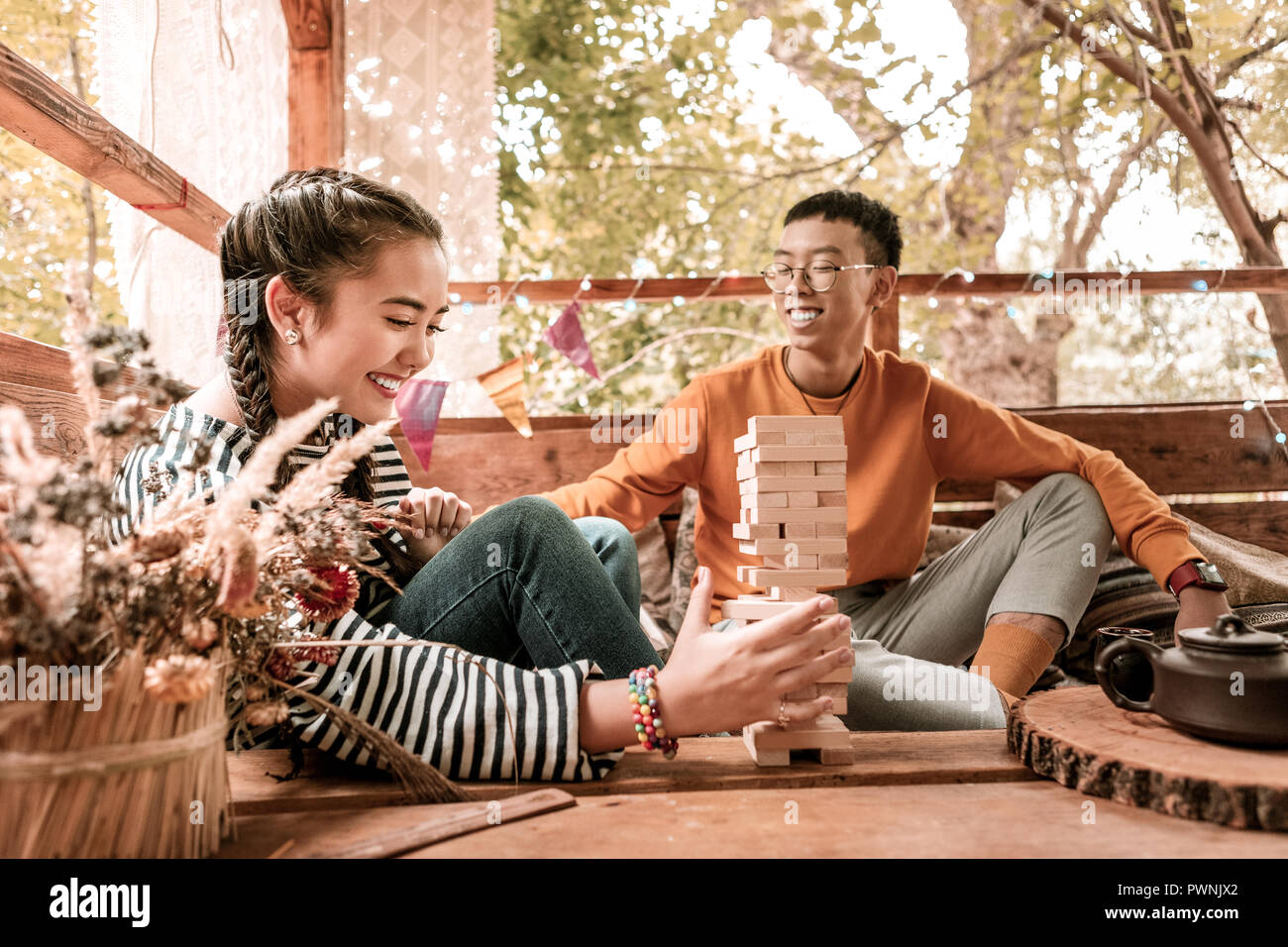 Beautiful female person sitting in semi position Stock Photo - Alamy