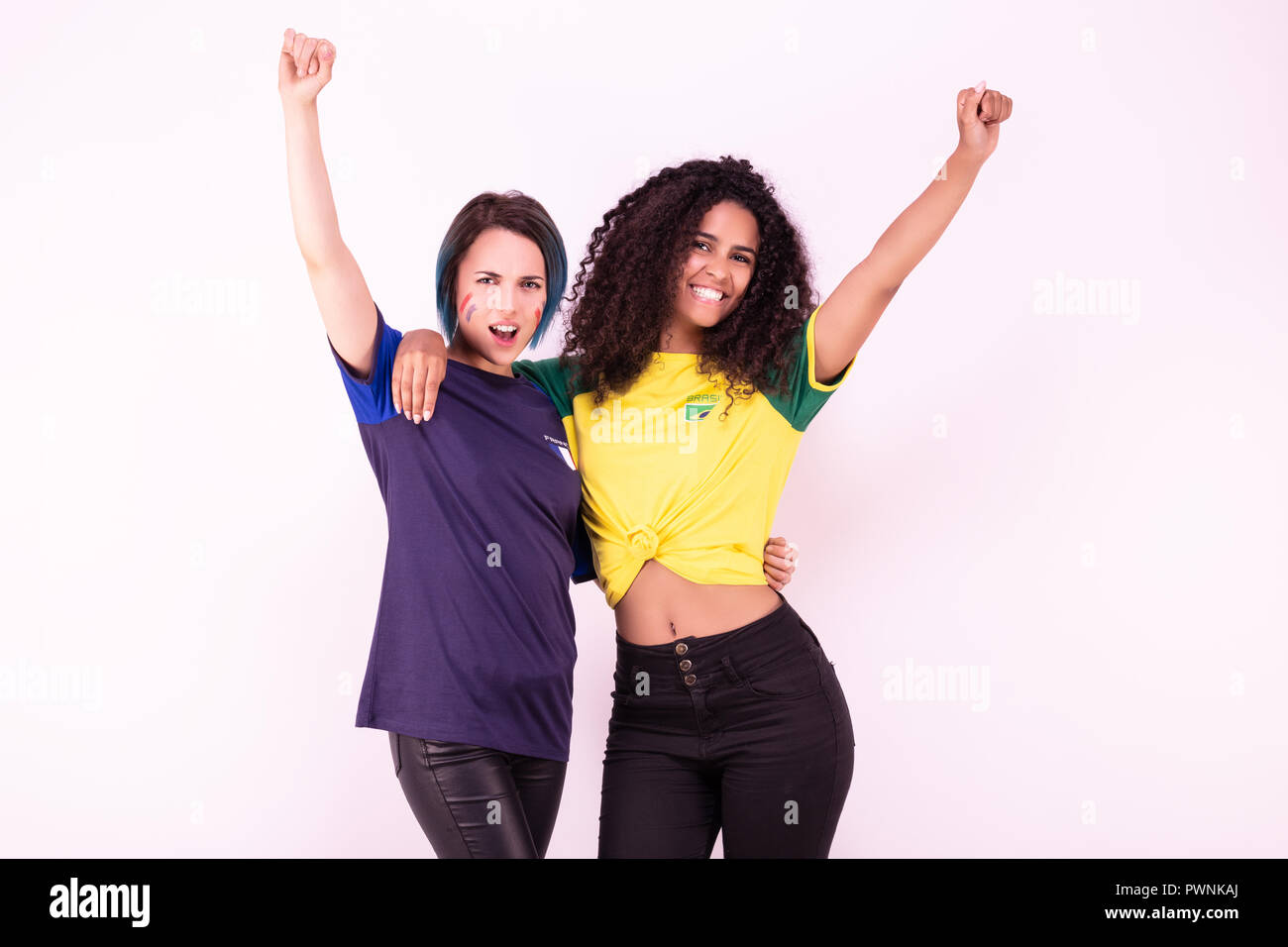 Portrait of two young fans of the Brazilian team and the French ...