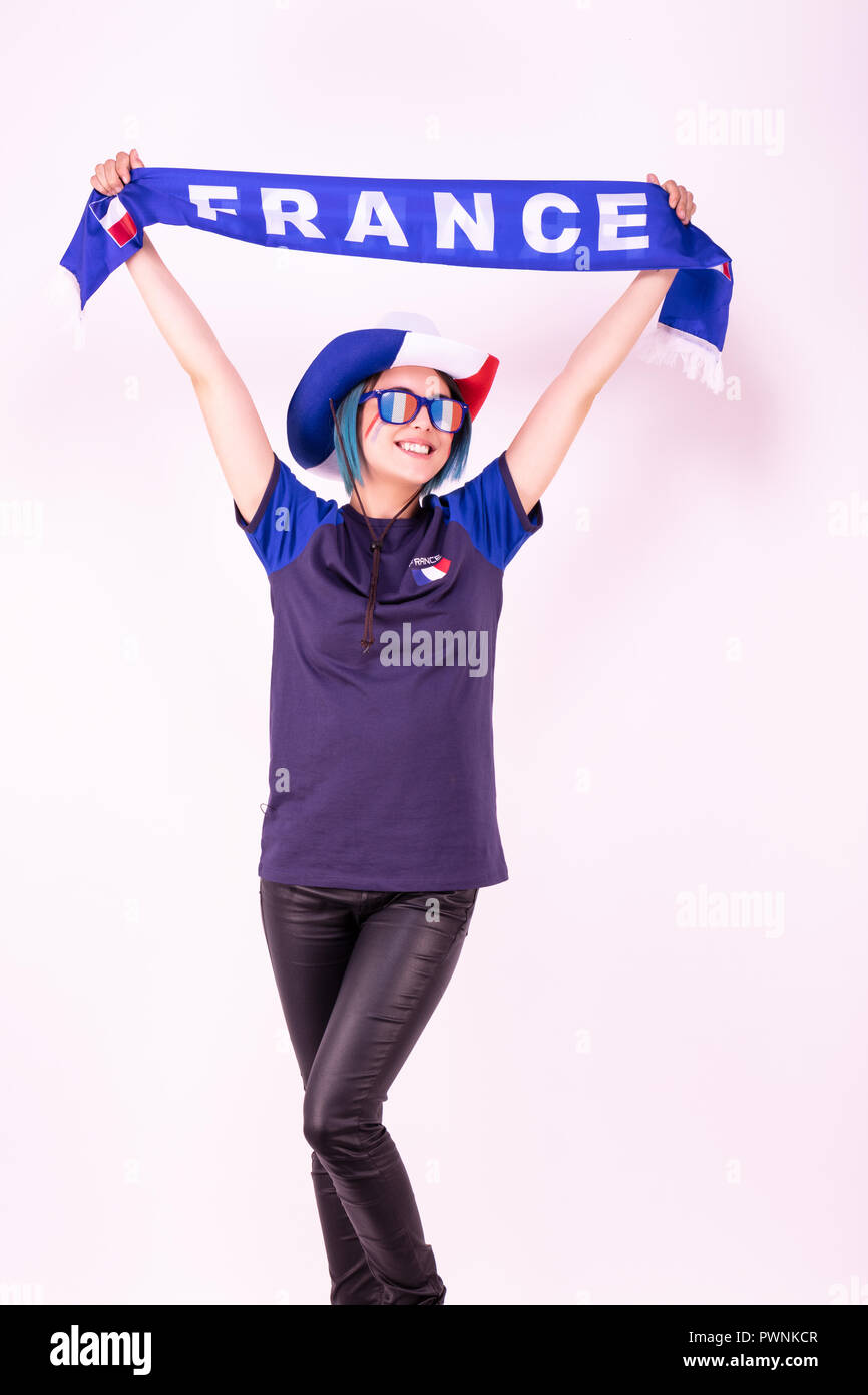 Portrait of a young supporter of the French football team wearing a hat ...