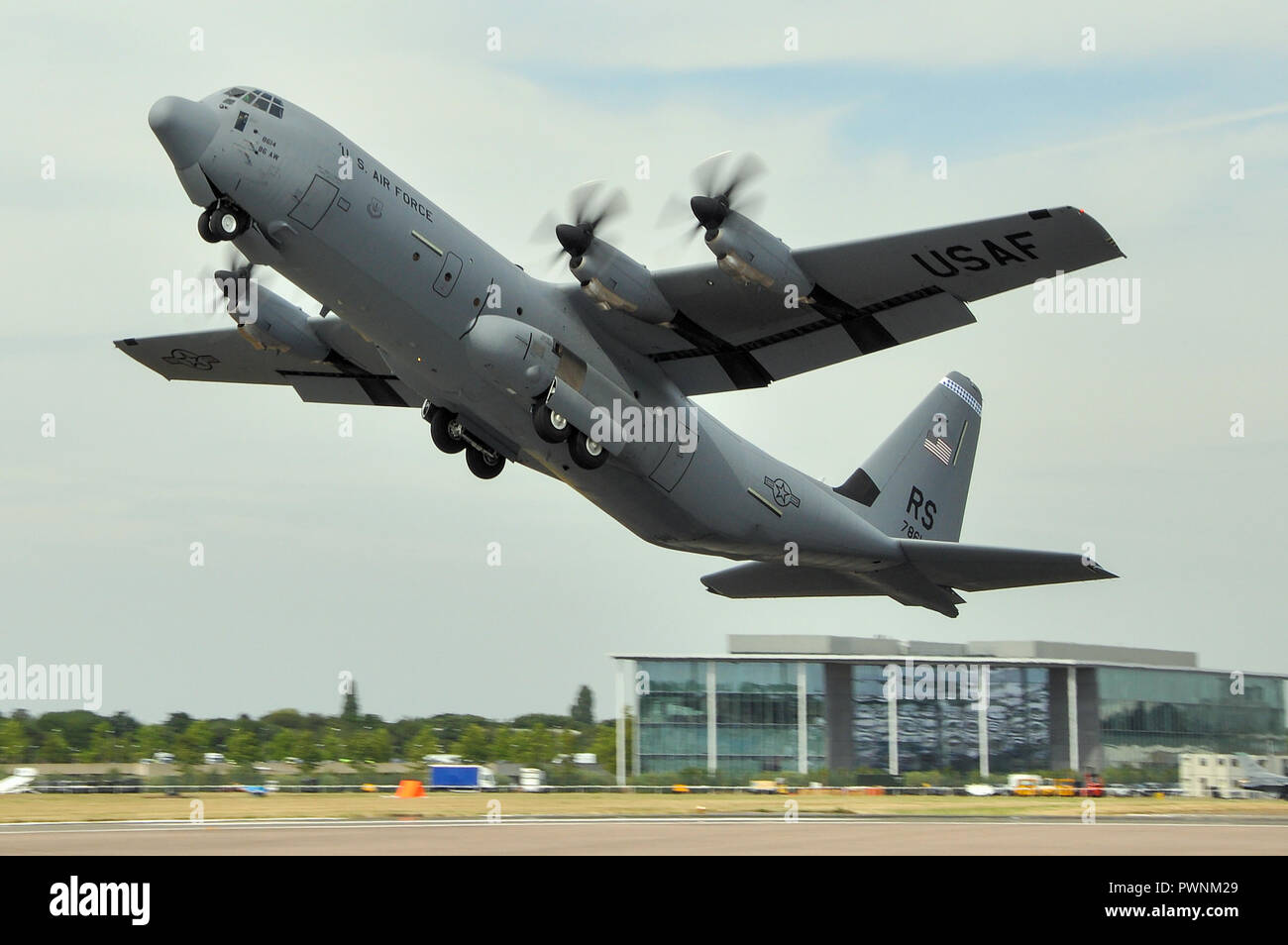 Lockheed C-130J Hercules leaping into the air. Steep climb taking off ...