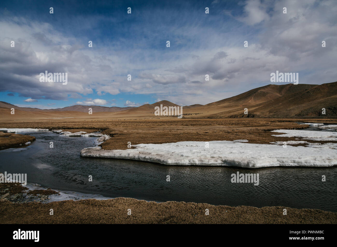 Landscape of a newly thawed river beginning to flow in the Mongolian ...