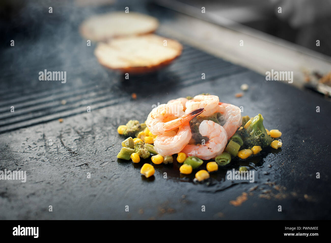 The process of cooking shrimps with vegetables on the street. Asian and ...