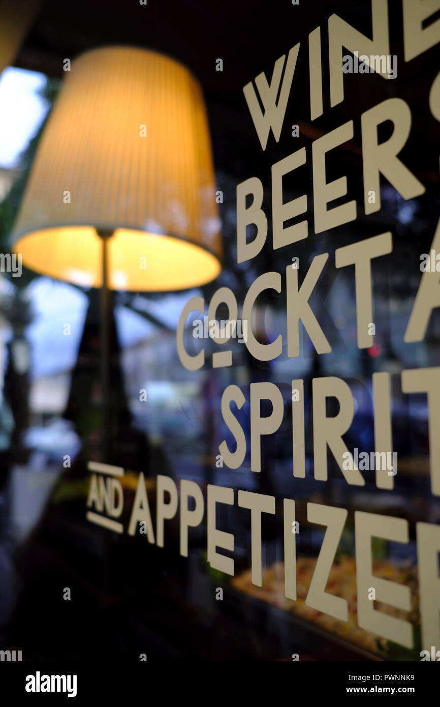 Bar window with lamp and signs Stock Photo - Alamy