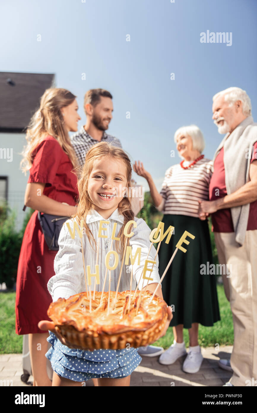 Positive delighted child holding cake in both hands Stock Photo - Alamy